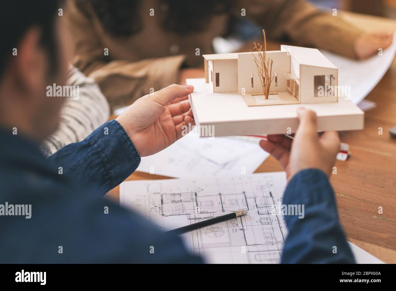Engineer holding blueprint house model hi-res stock photography and ...