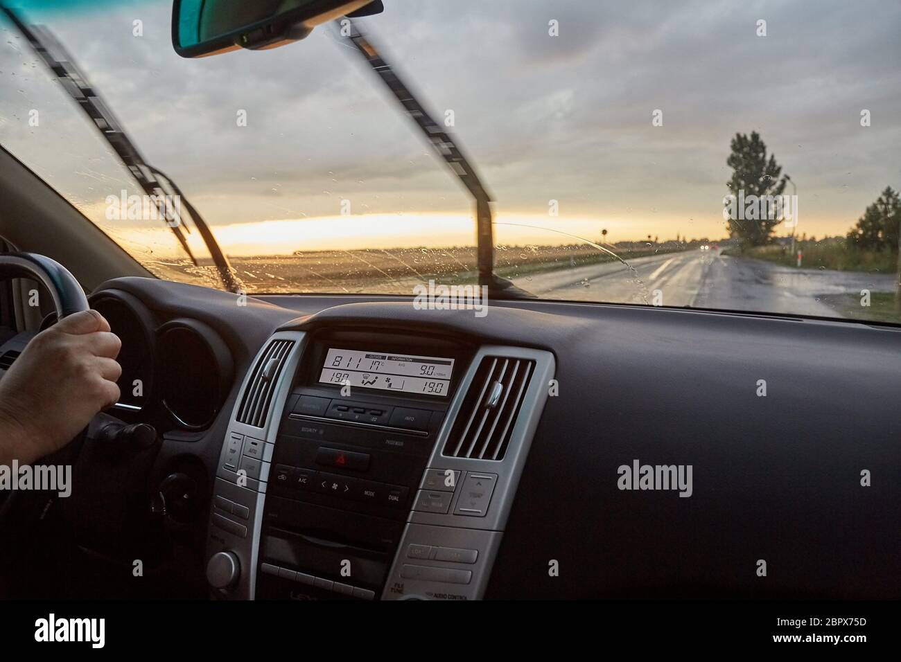 Driving a car in rain, interior view from passenger seat Stock Photo ...