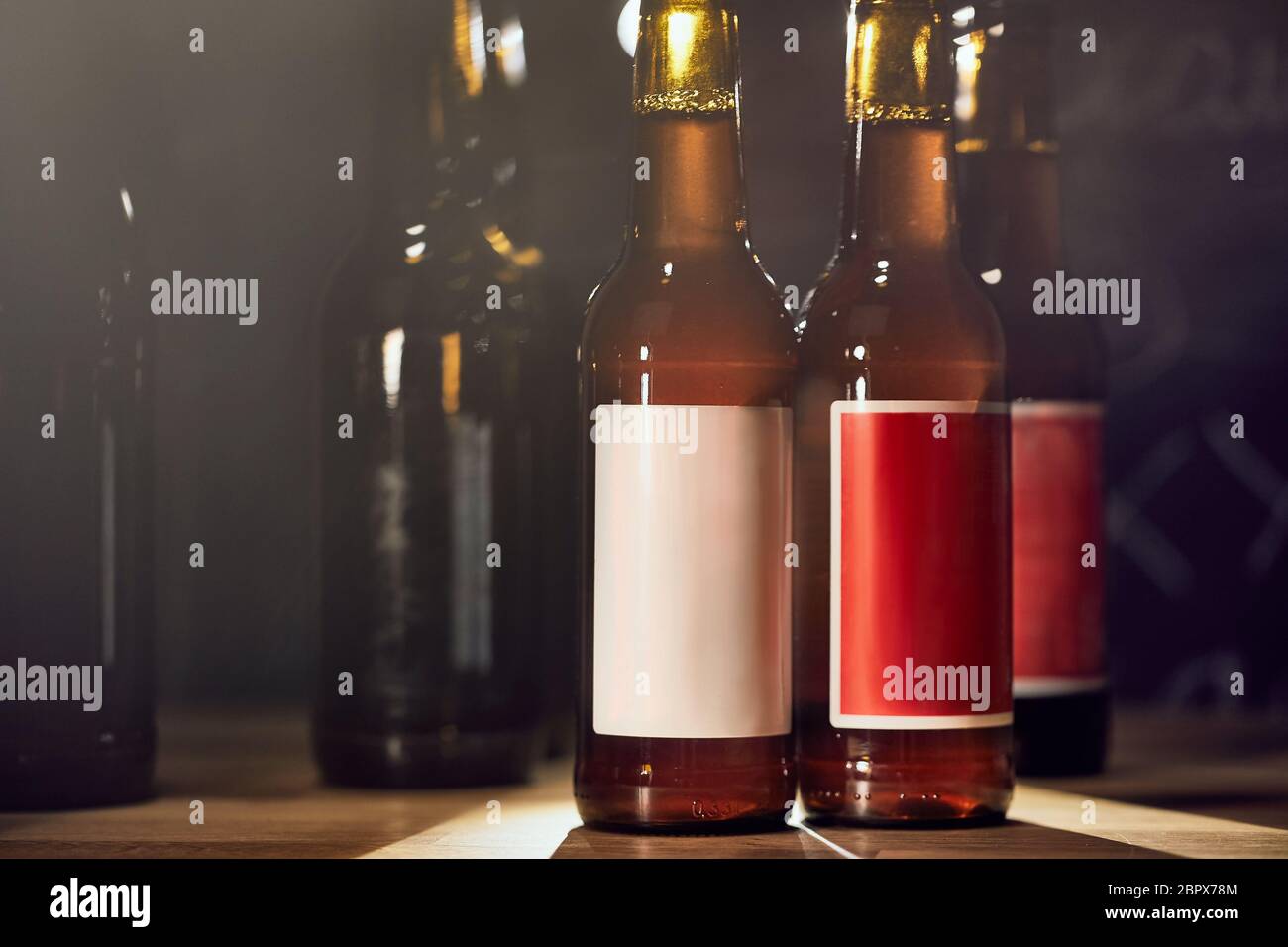 Beer bottles on a bar counter Stock Photo - Alamy