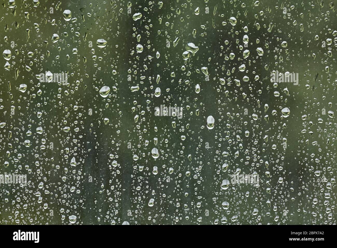 Raindrops falling down window glass hi-res stock photography and images ...