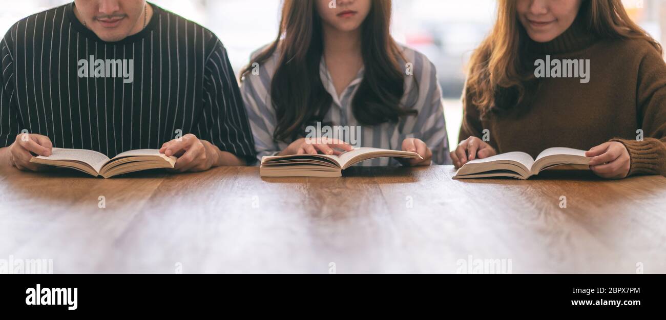 Group of young people sitting and enjoyed reading books together on ...