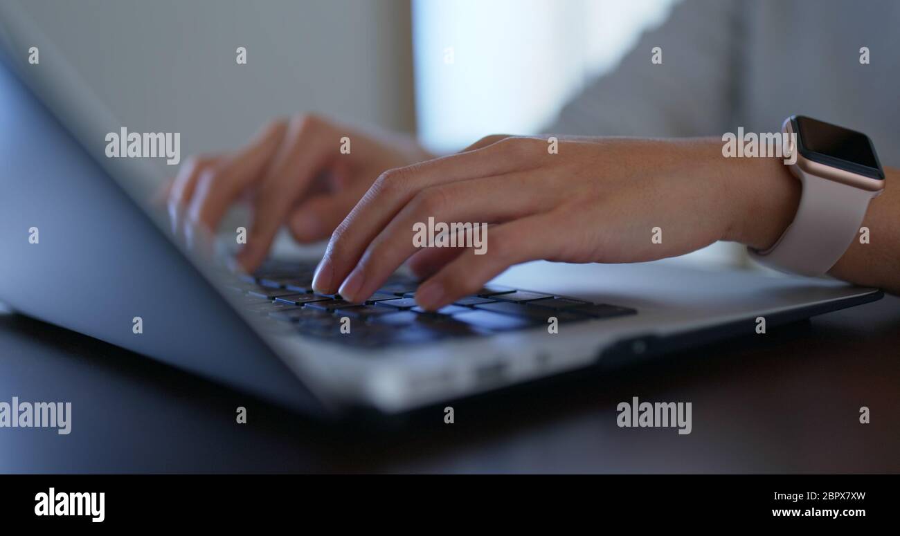 Woman type on computer at home Stock Photo - Alamy