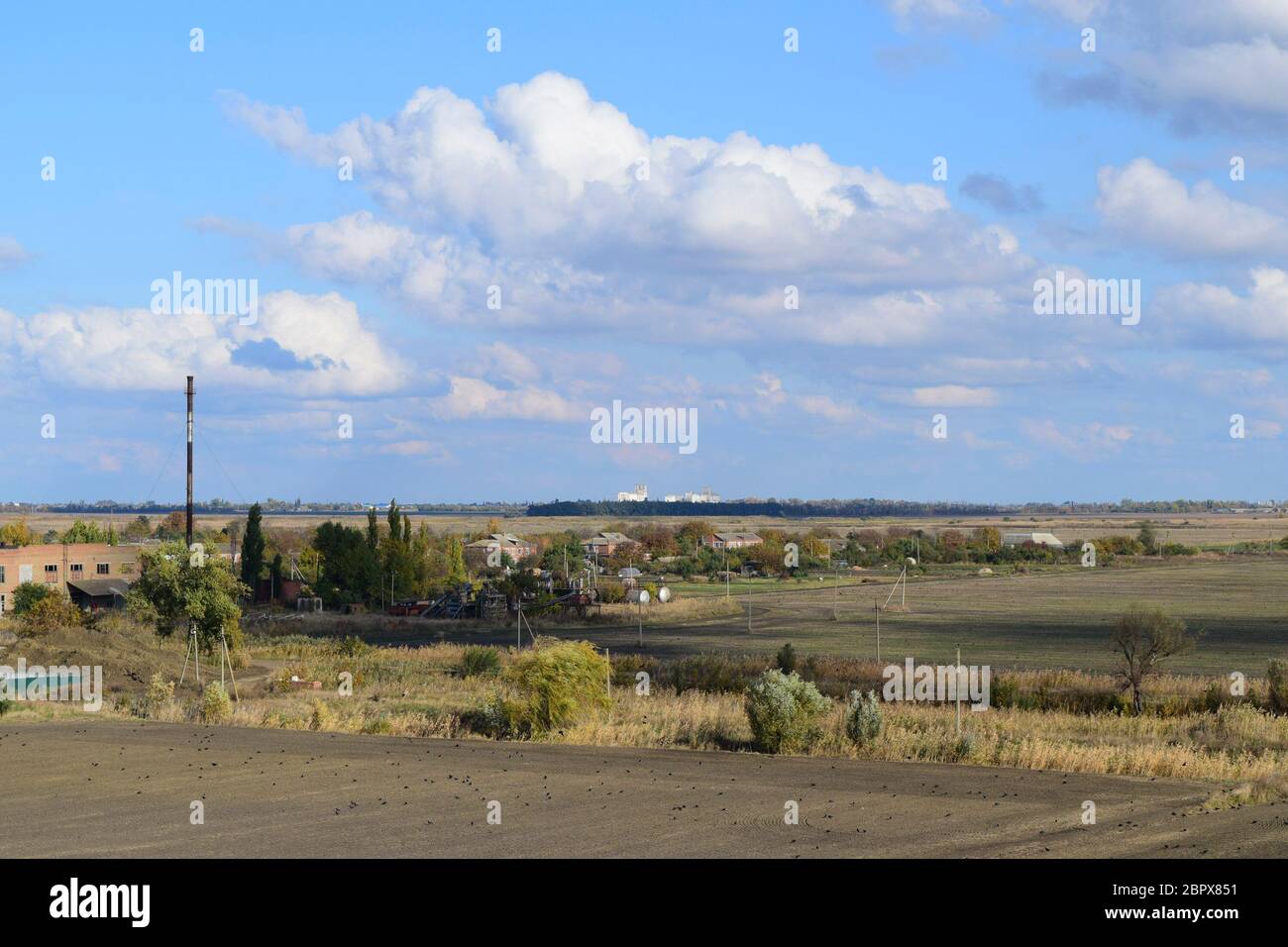 A view from above of a small Russian village. Rural landscape. Field ...