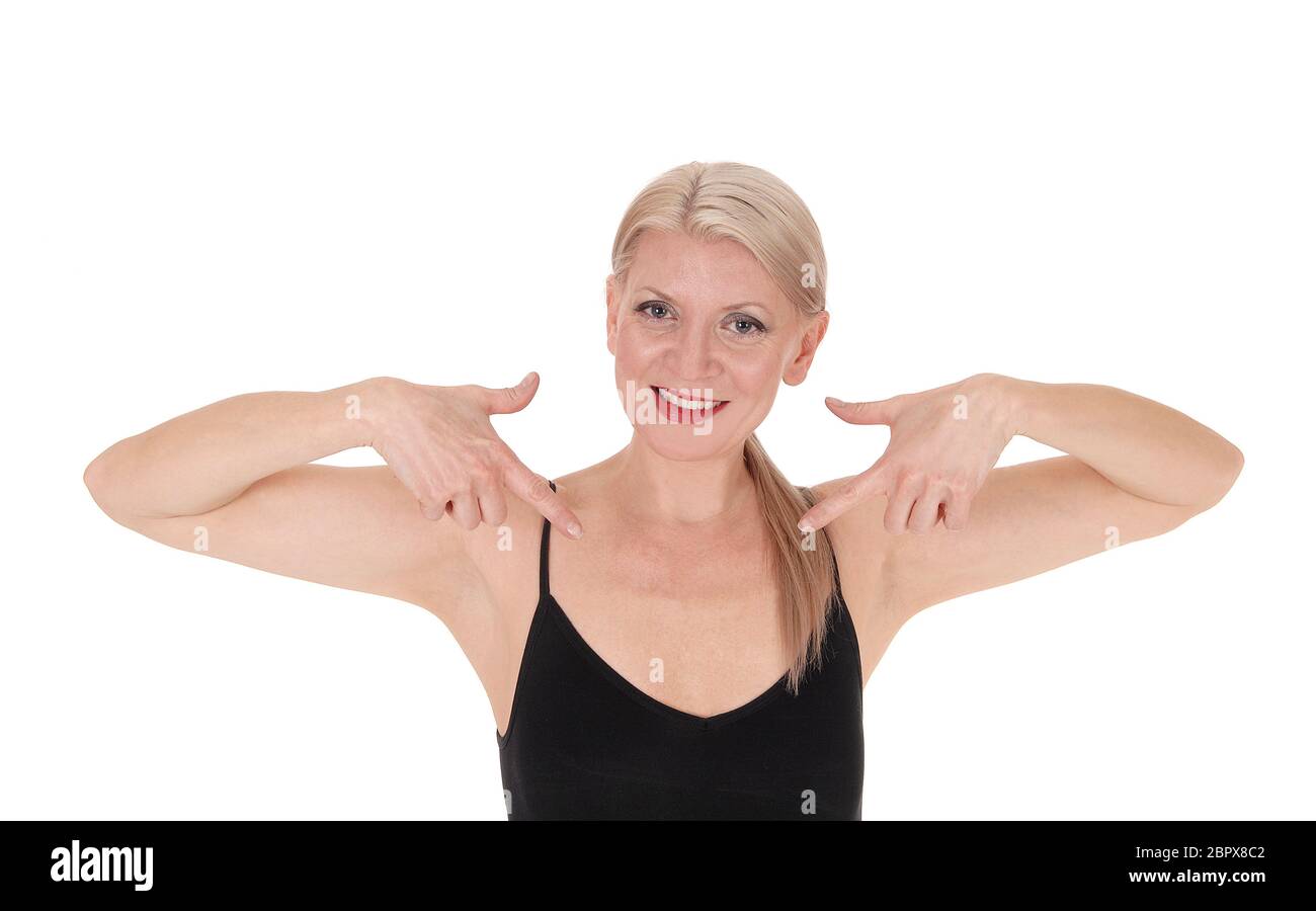 A close up image of a smiling blond woman in a black top pointing with ...
