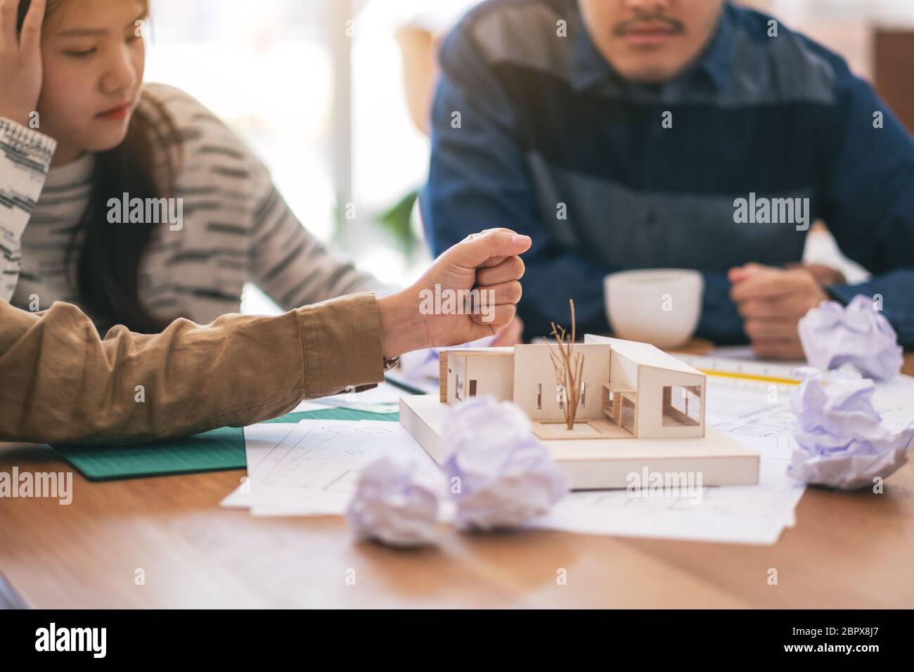 Closeup image of an angry and stressed architects try to destroy an ...