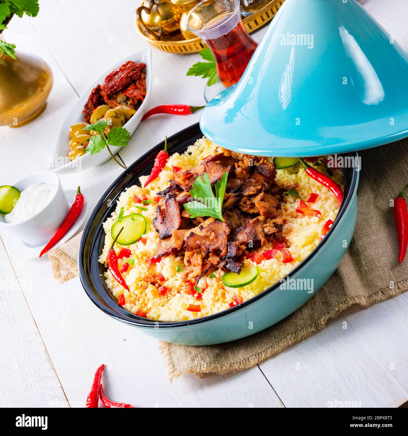 Tajin with couscous, vegetables and meat on white background Stock ...