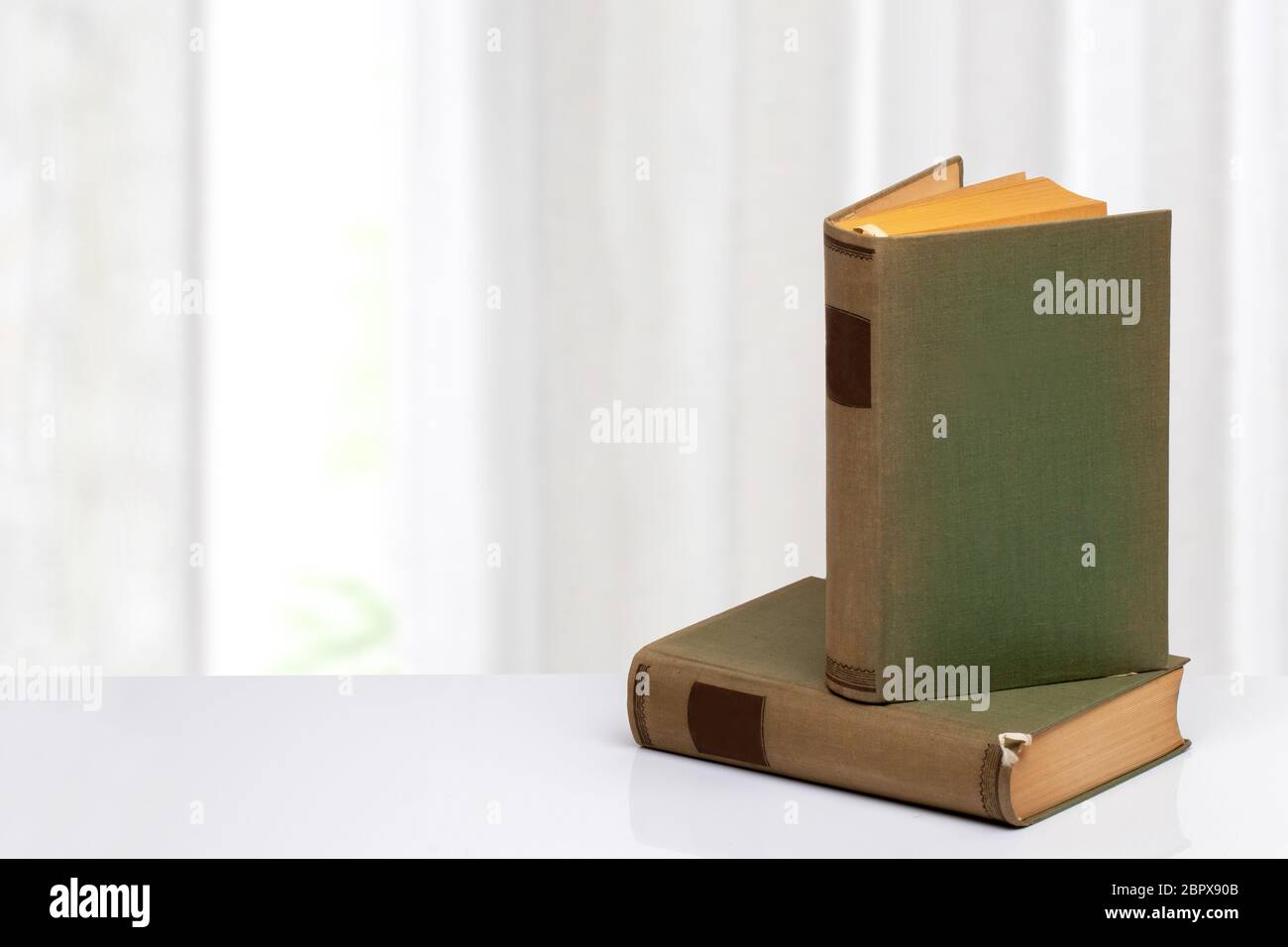 Books backgrounds. Close-up of two antique books on a white table in ...