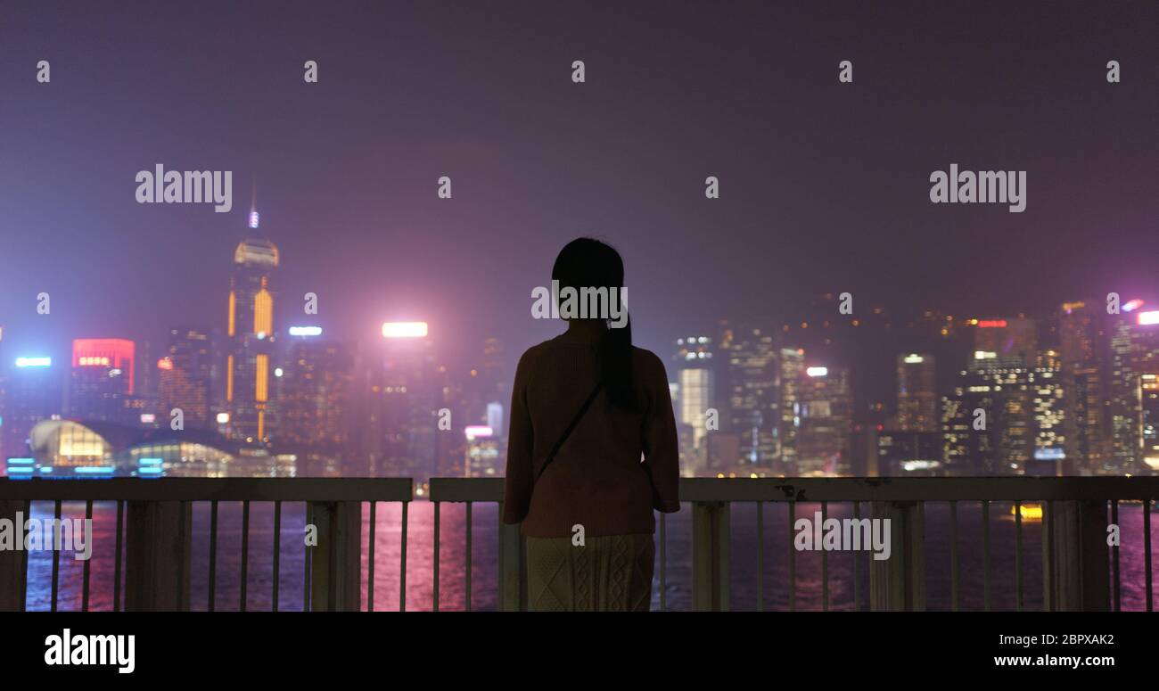 Woman look at the view in the city at night Stock Photo - Alamy