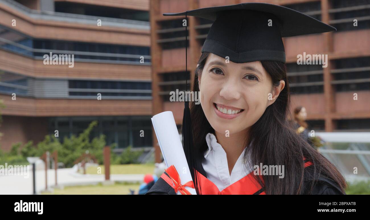 Woman get graduation and holding paper certificate Stock Photo - Alamy