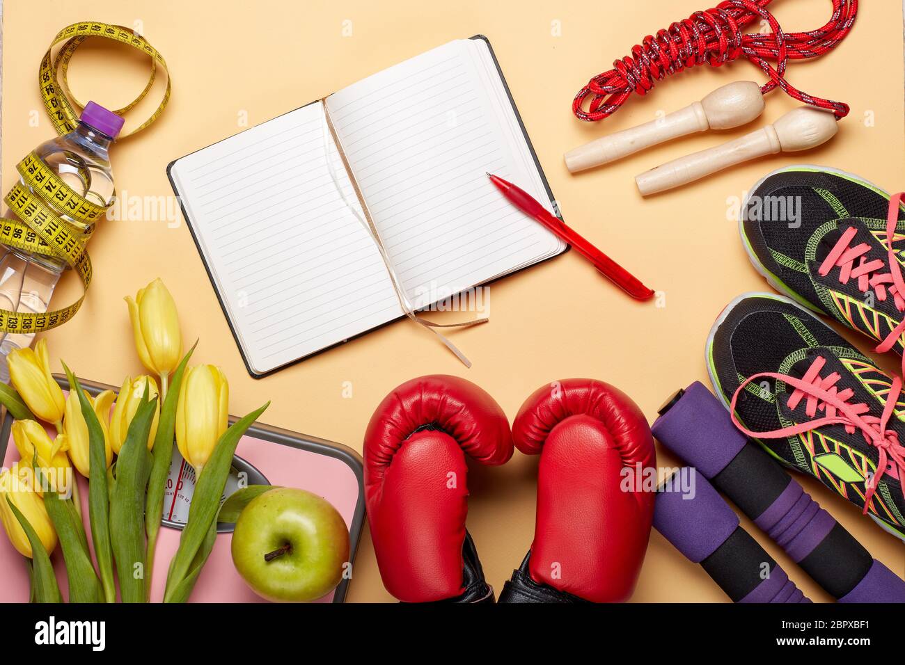 Female fitness still life. Sport accessories, tulips flowers and scales ...