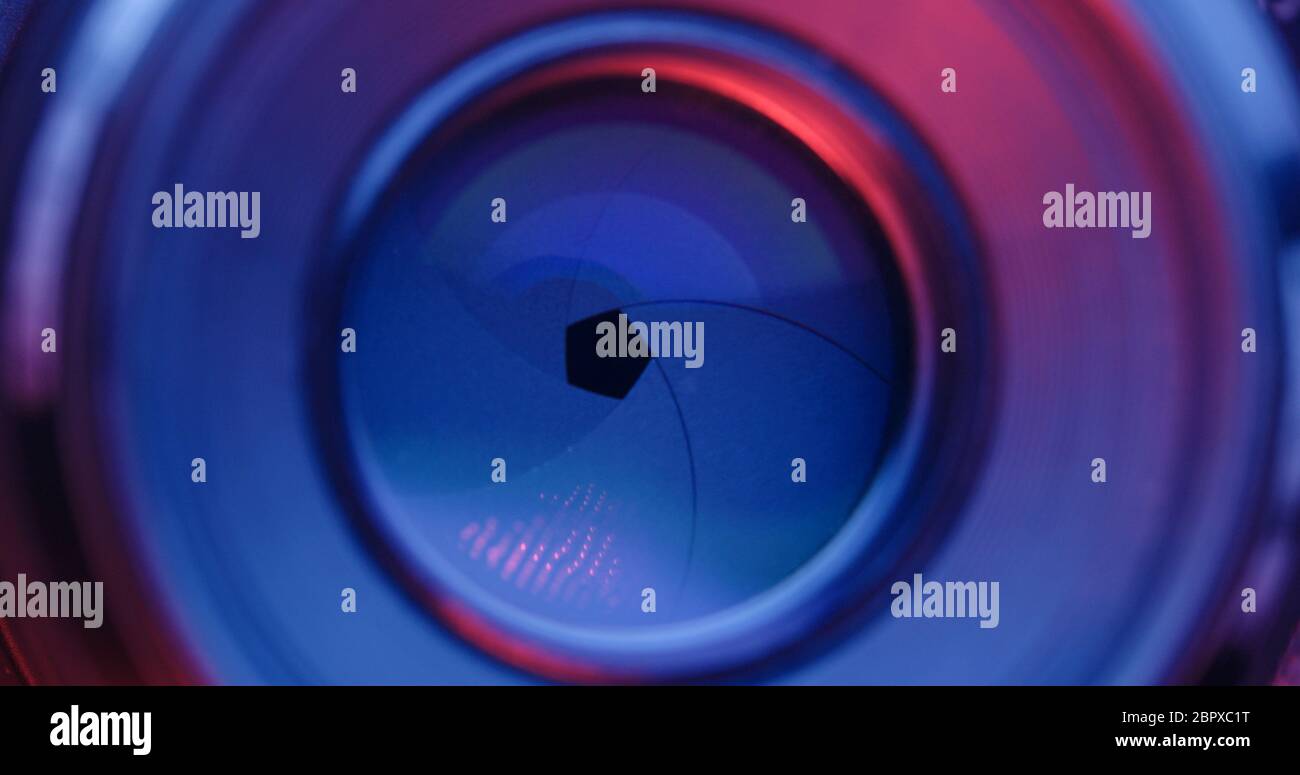 Adjusting Camera lens aperture with pink and purple Stock Photo - Alamy
