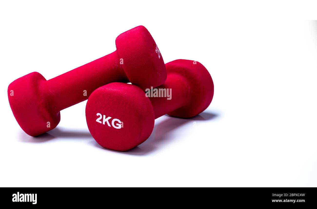 Set of red dumbbells isolated on white background. A pair of red neoprene dumbbells. Home gym ...