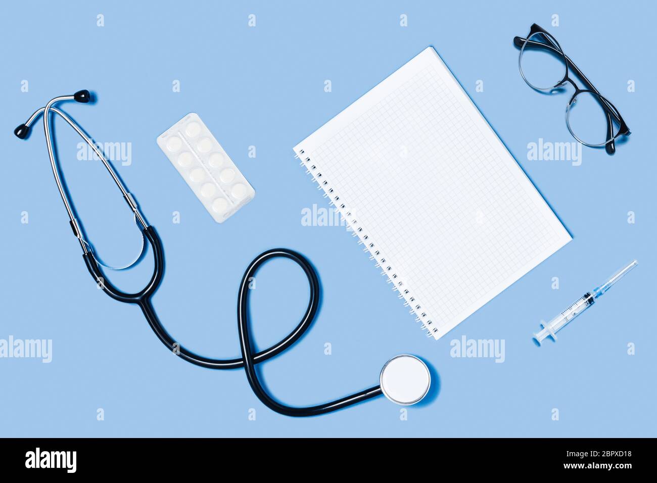 Medical blue background with different accessories: stethoscope ...