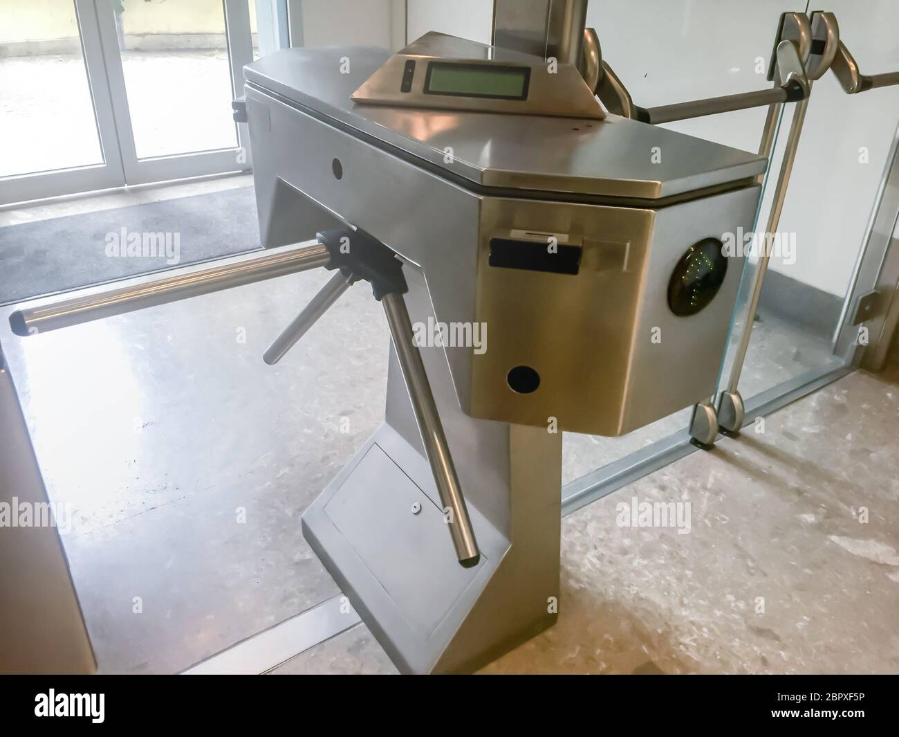 Metal turnstile at the entrance of an office. Turnstile is a mechanical ...