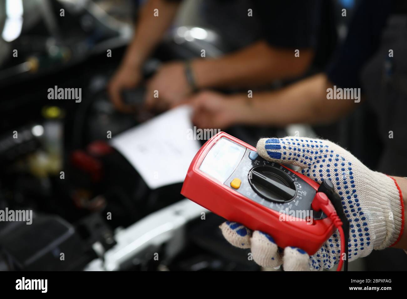 Garage worker fixing vehicle Stock Photo - Alamy