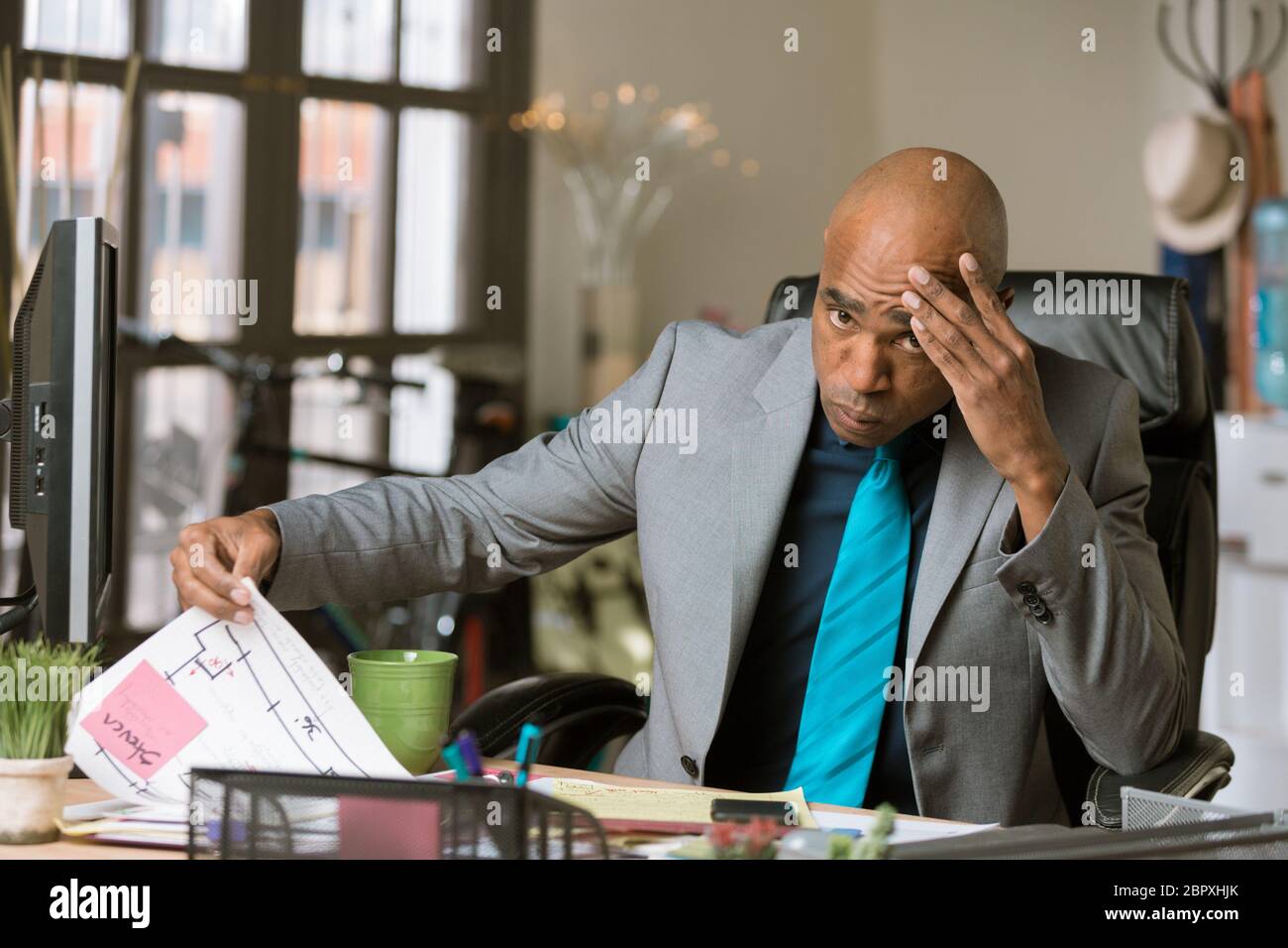 Stressed professional man in his office Stock Photo - Alamy