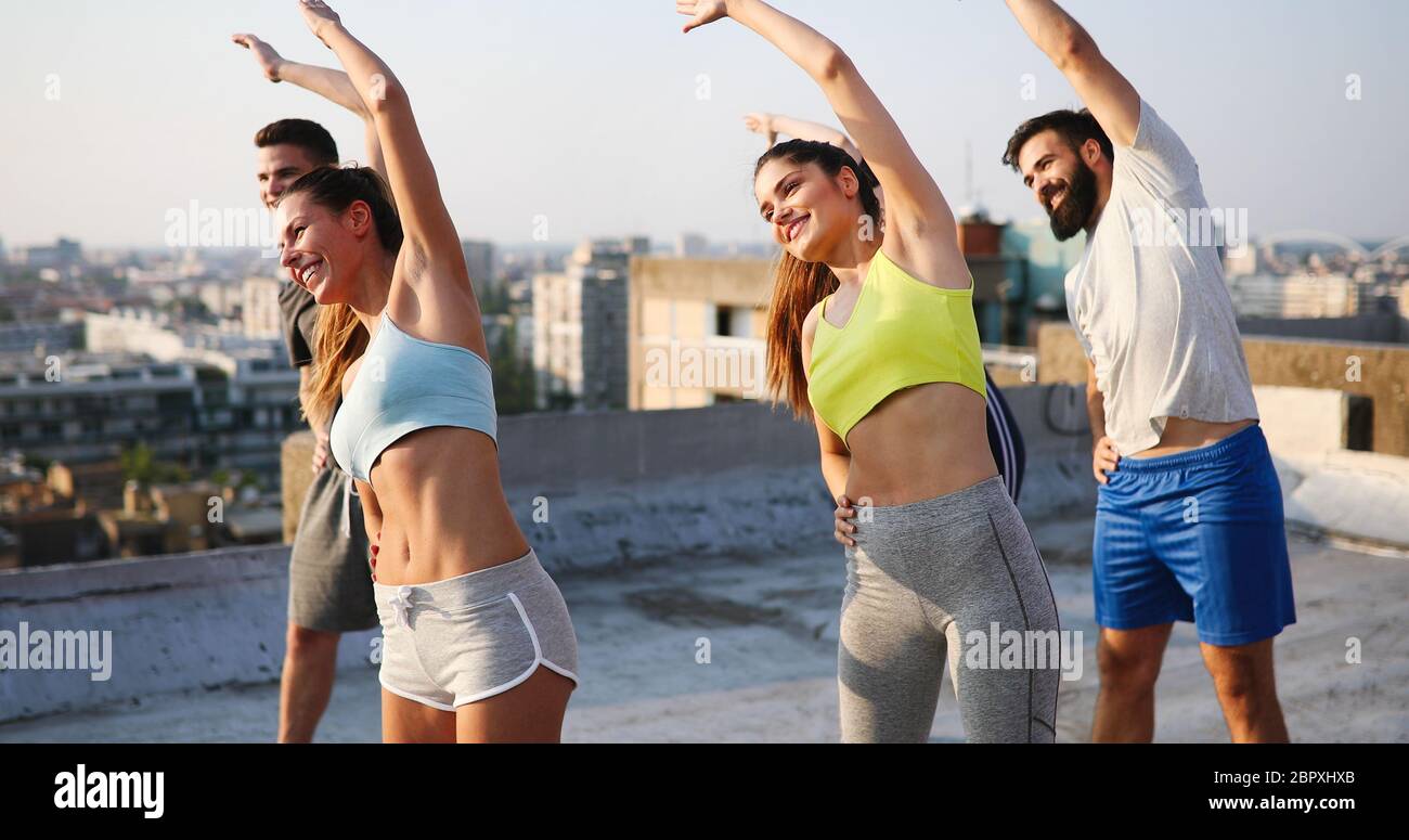 Group of fit healthy friends, people exercising together outdoor Stock ...