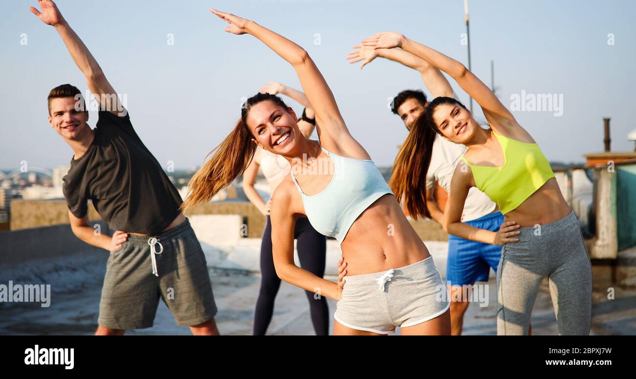 Group of fit healthy friends, people exercising together outdoor Stock ...