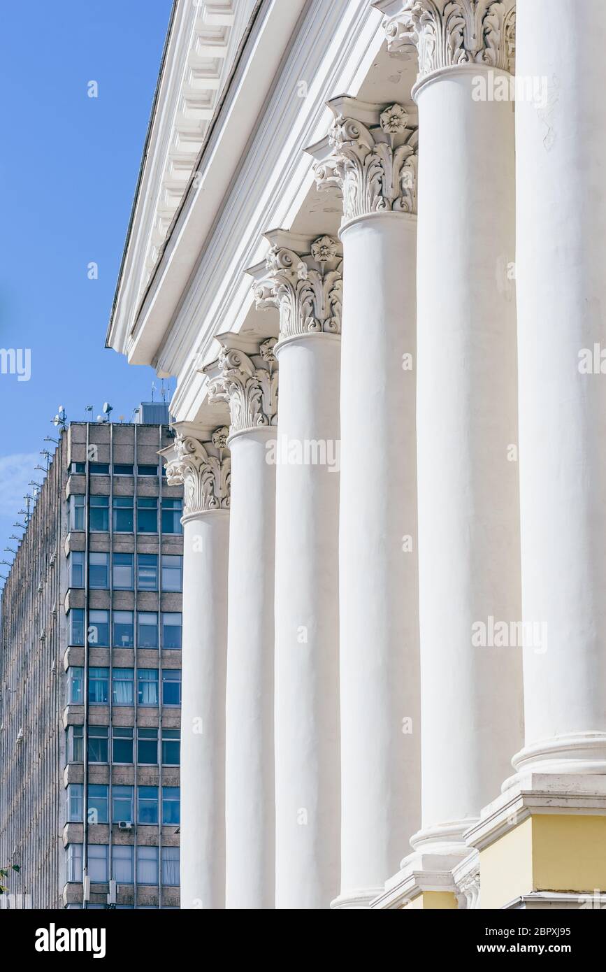 Front of Old Buildig with Columns and Skyscrapper on Background ...