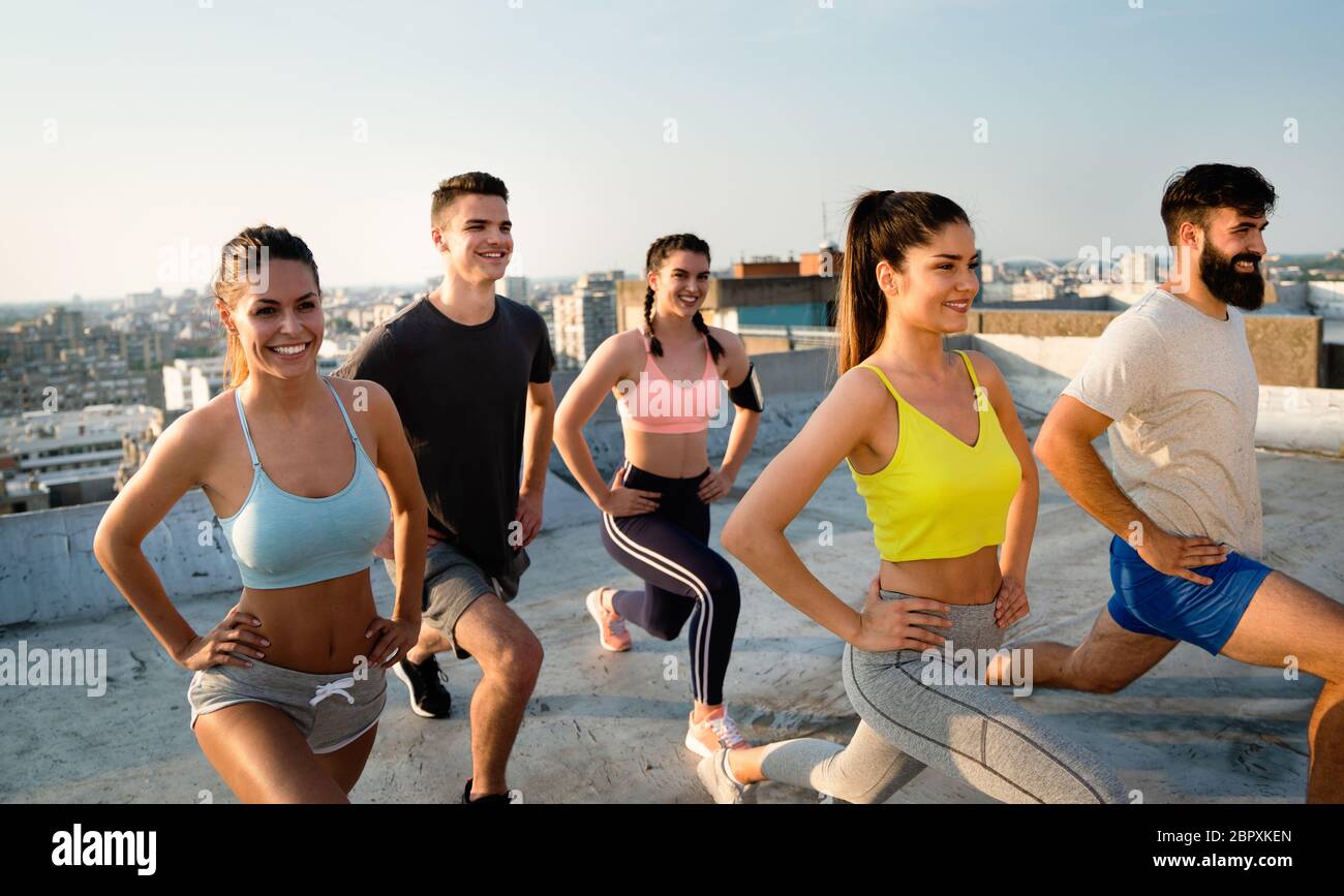 Group of fit healthy friends, people exercising together outdoor Stock ...