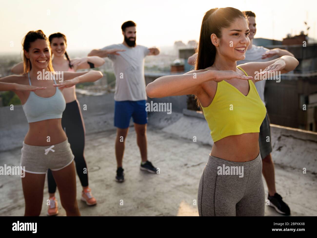 Group of fit healthy friends, people exercising together outdoor Stock ...