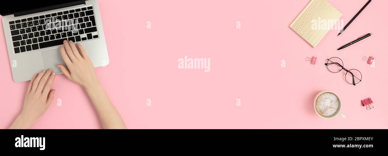 Female hands typing on laptop. Student workspace with stationery on a ...