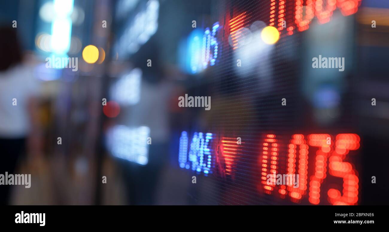 Stock market display screen in city at night Stock Photo - Alamy