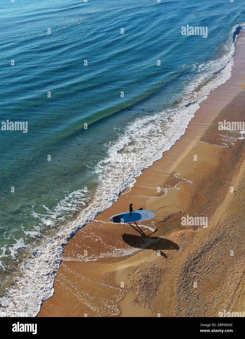 Sunset paddleboarding on sea aerial hi-res stock photography and images ...
