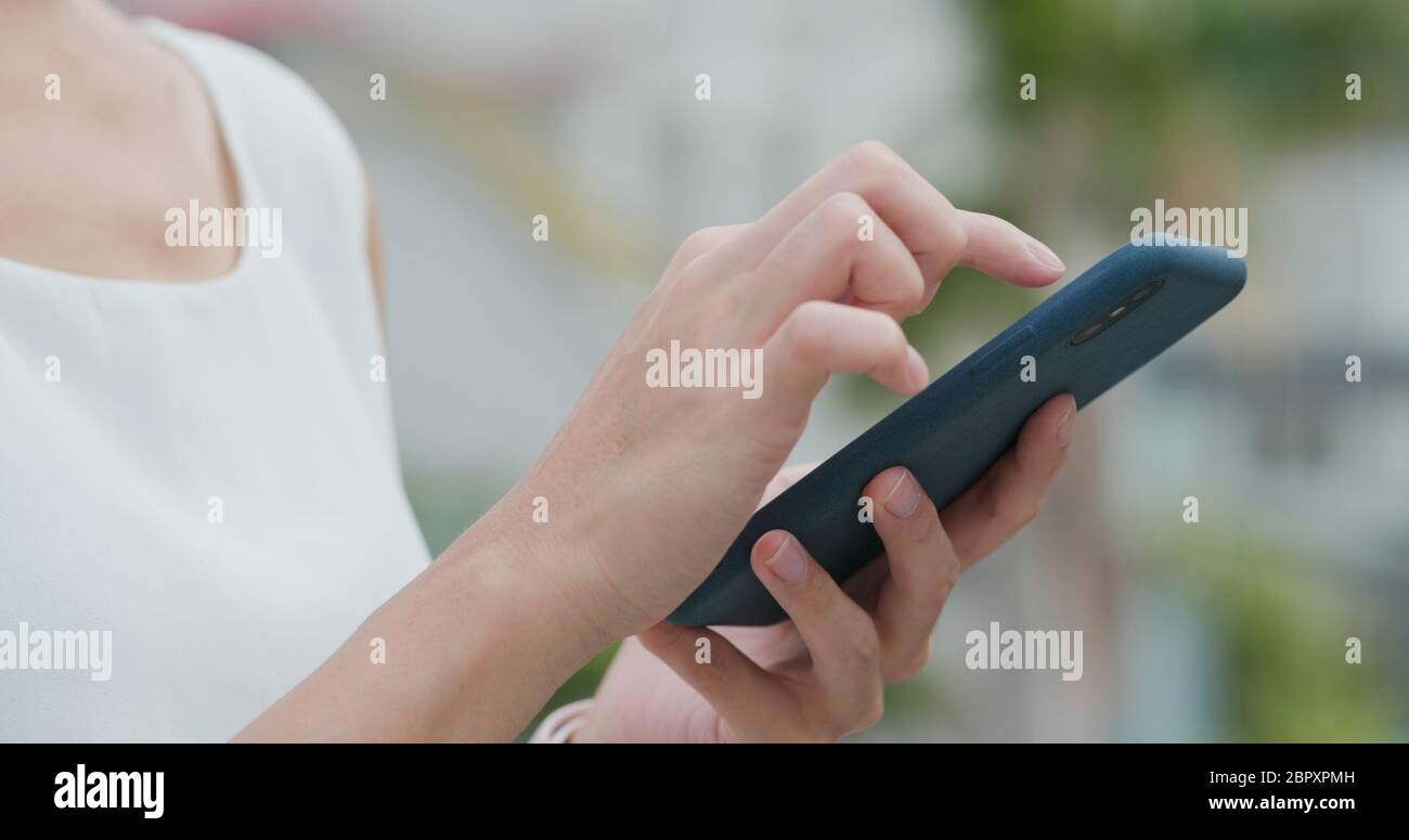 Woman using mobile phone online Stock Photo - Alamy