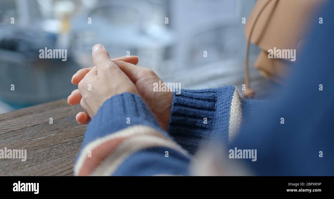 Woman finger cross and wait for someone Stock Photo - Alamy