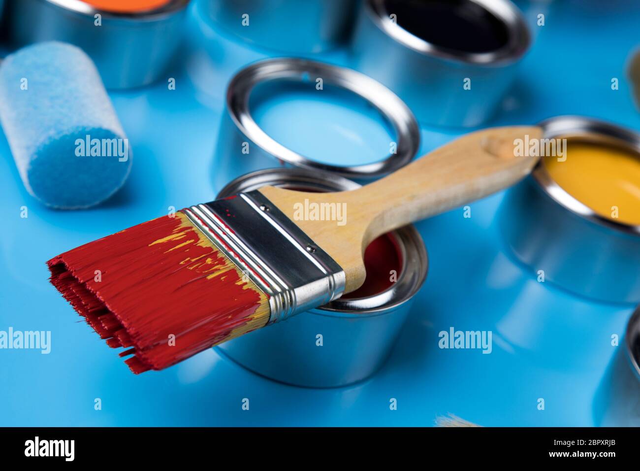 Tin cans with paint, brushes and bright palette of colors Stock Photo ...