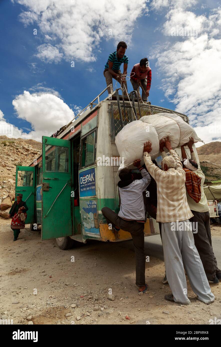 People loading Luggage on the top of the bus using local technic in ...
