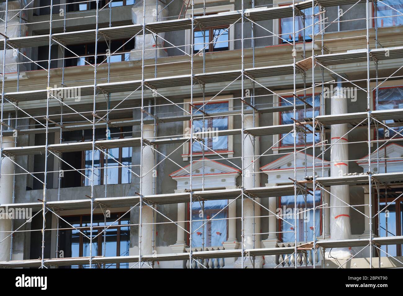 scaffolding at the facade of a building under construction, multi ...