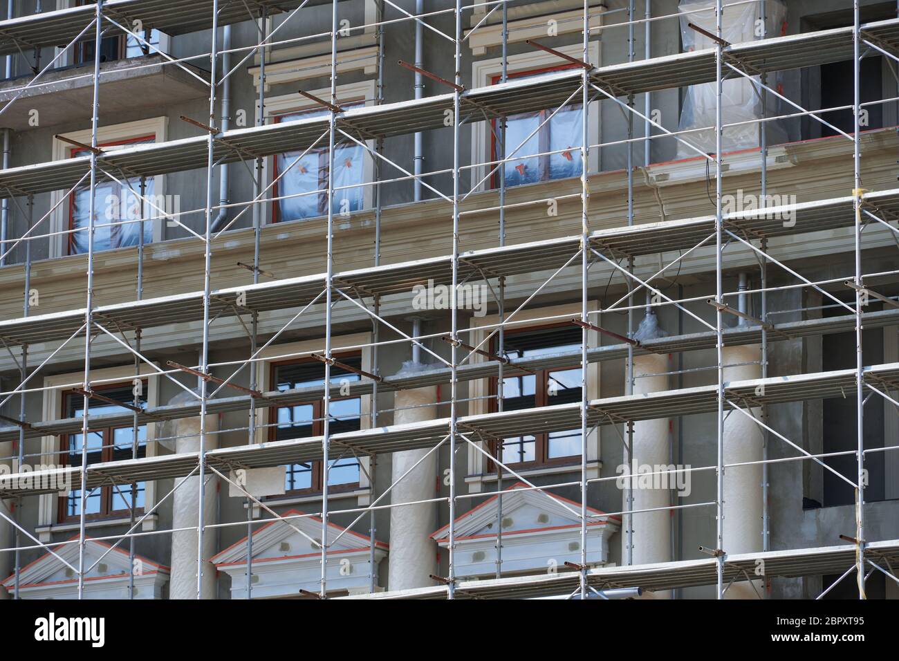 scaffolding at the facade of a building under construction, multi ...