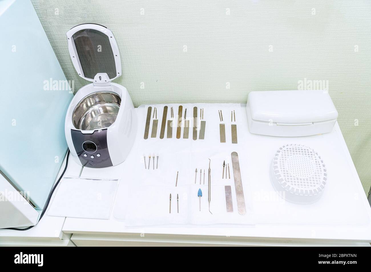 Tools for hardware manicure. Cutters and files. Place for disinfection ...