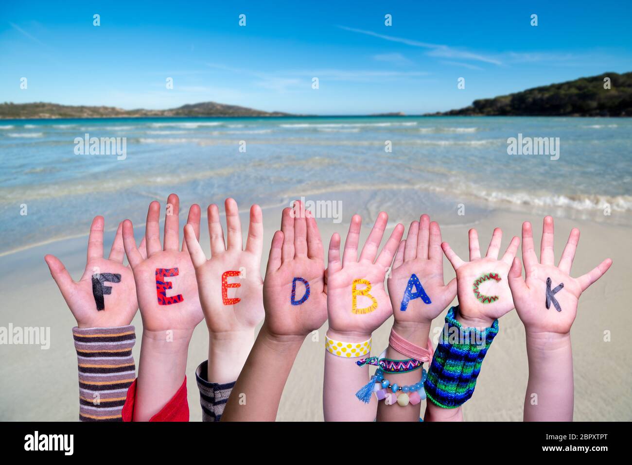 Children Hands Building Word Feedback, Ocean Background Stock Photo - Alamy