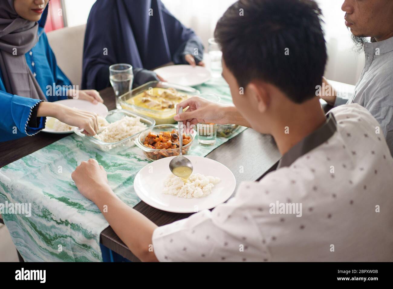 Happy muslim family fun table hi-res stock photography and images - Alamy