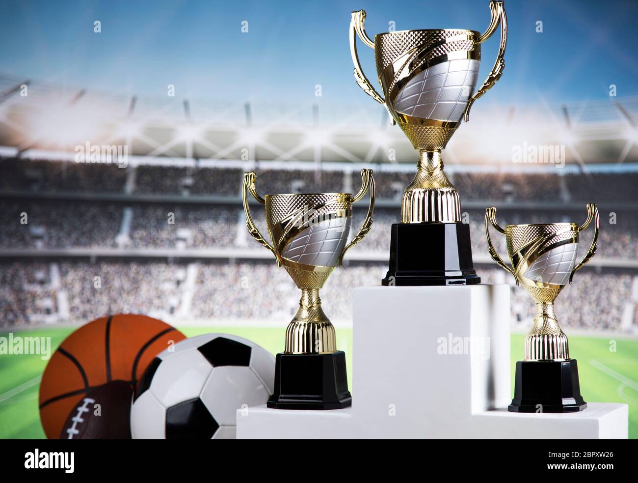 Cups of winners award on white podium, sport background Stock Photo - Alamy