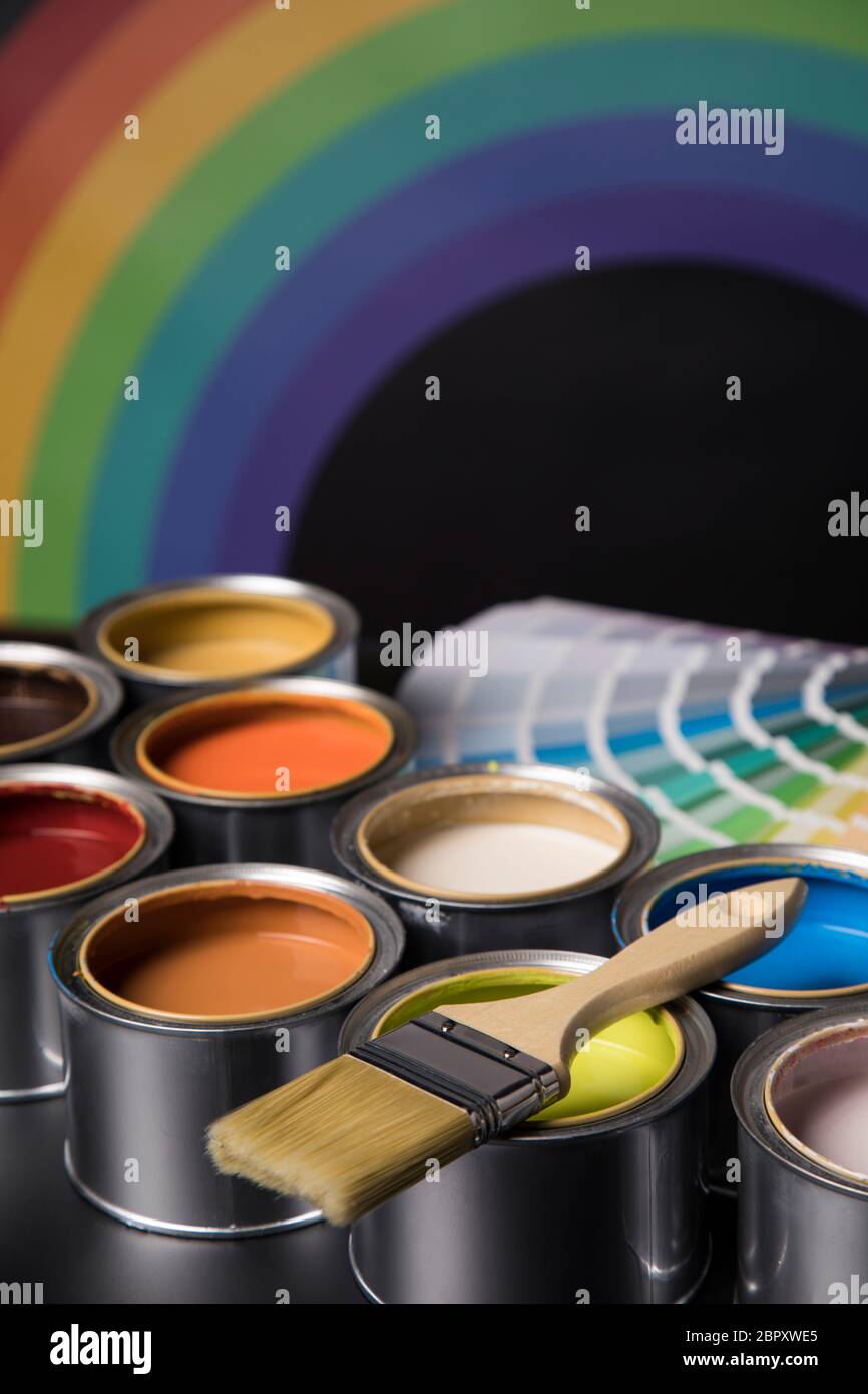 Tin cans with paint, brushes and bright palette of colors Stock Photo ...