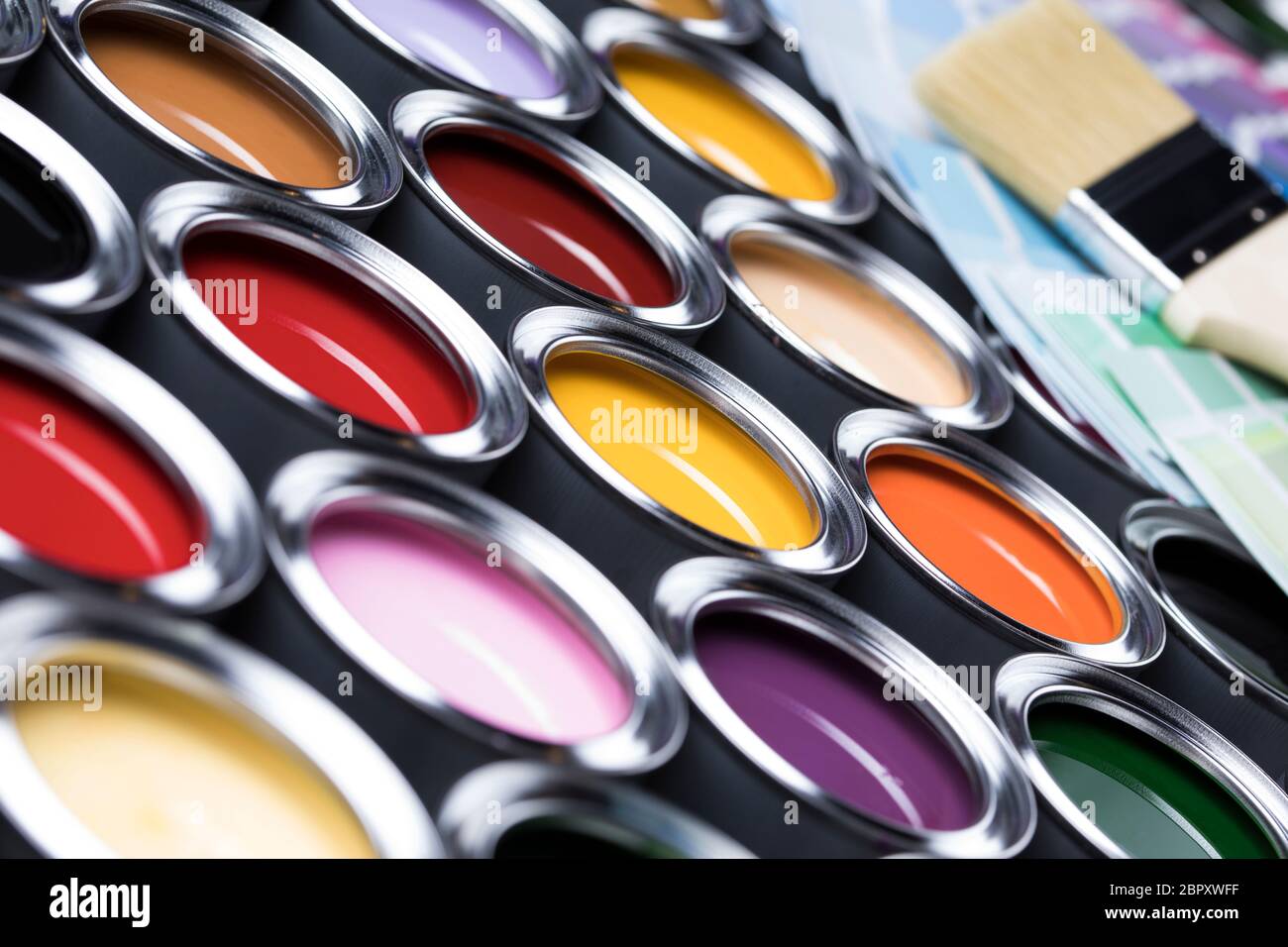 Metal tin cans with color paint and paintbrush Stock Photo - Alamy