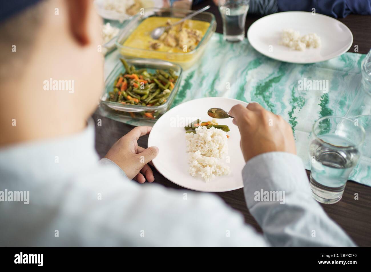 portrait close up of hand family muslim eating in dinning table ...