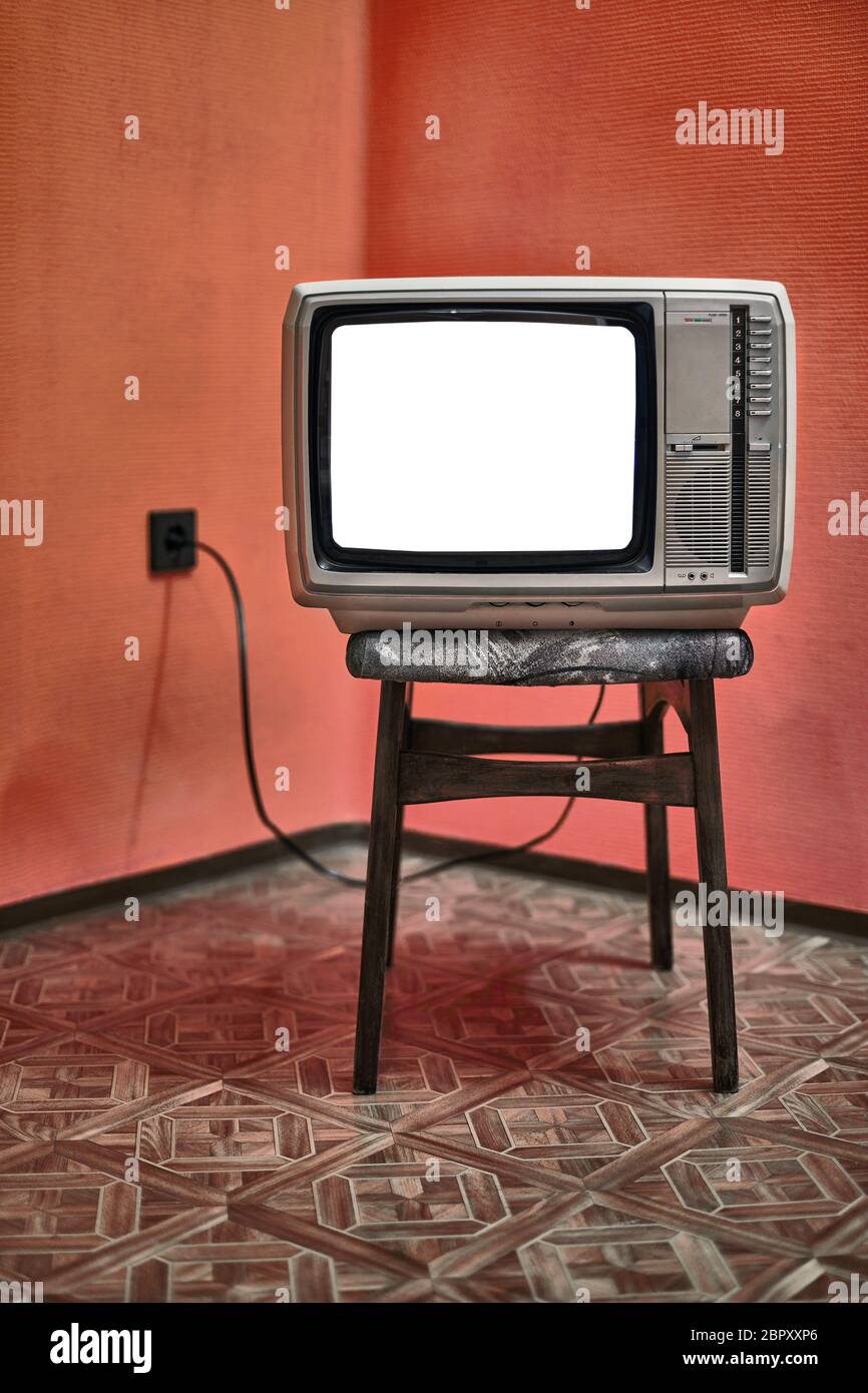 Vintage TV set on a chair with blank white screen Stock Photo - Alamy