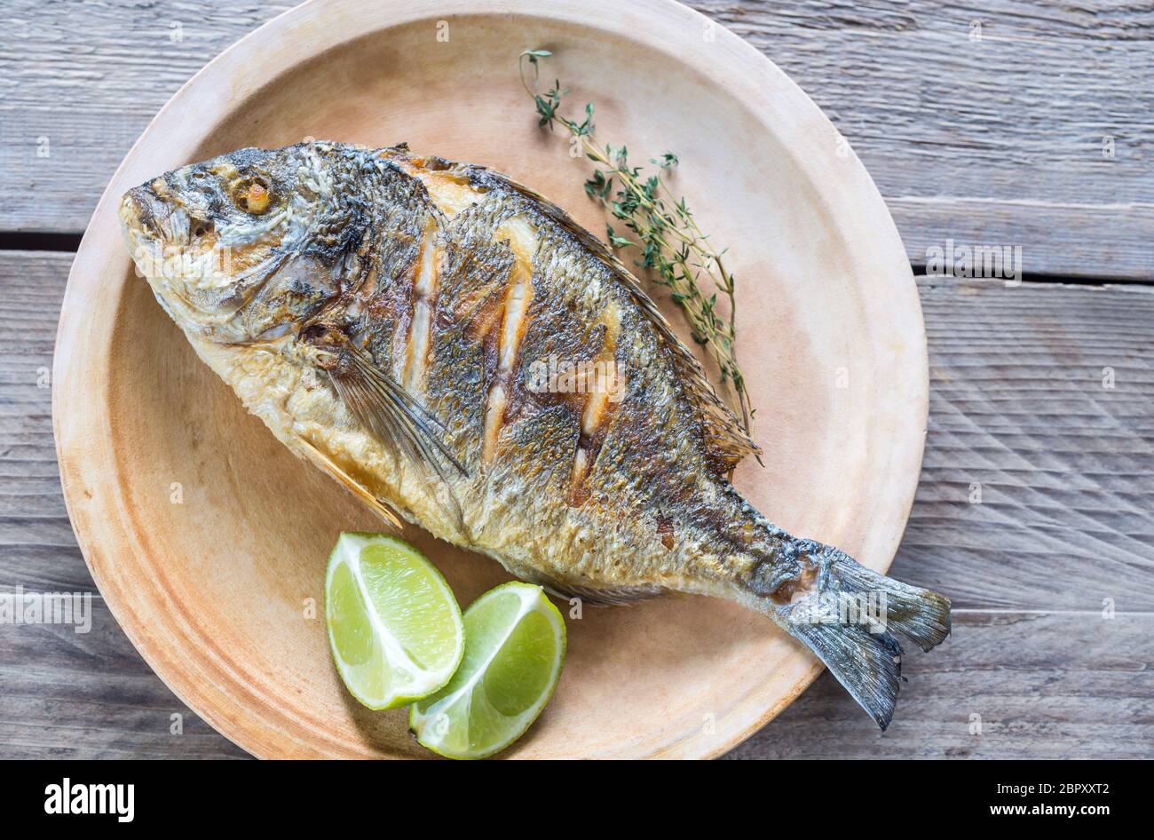 Grilled Dorade Royale Fish on the plate Stock Photo - Alamy