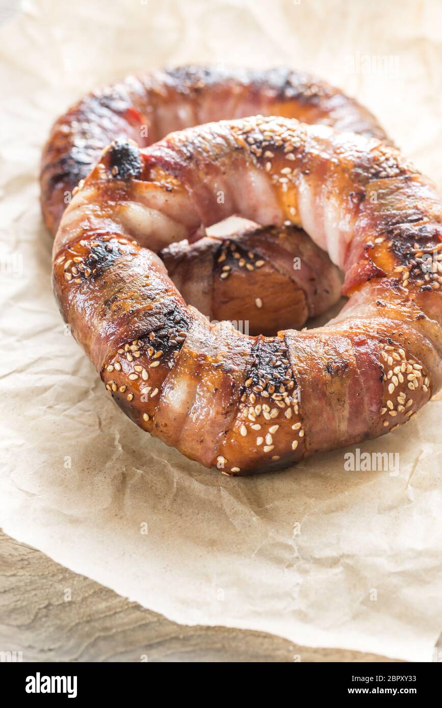 Bagels with sesame wrapped in bacon rashers Stock Photo - Alamy