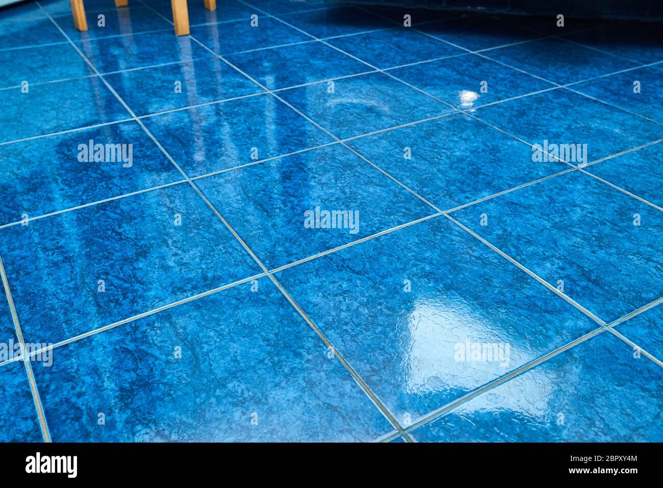Shiny blue tiled bathroom floor reflecting light Stock Photo - Alamy