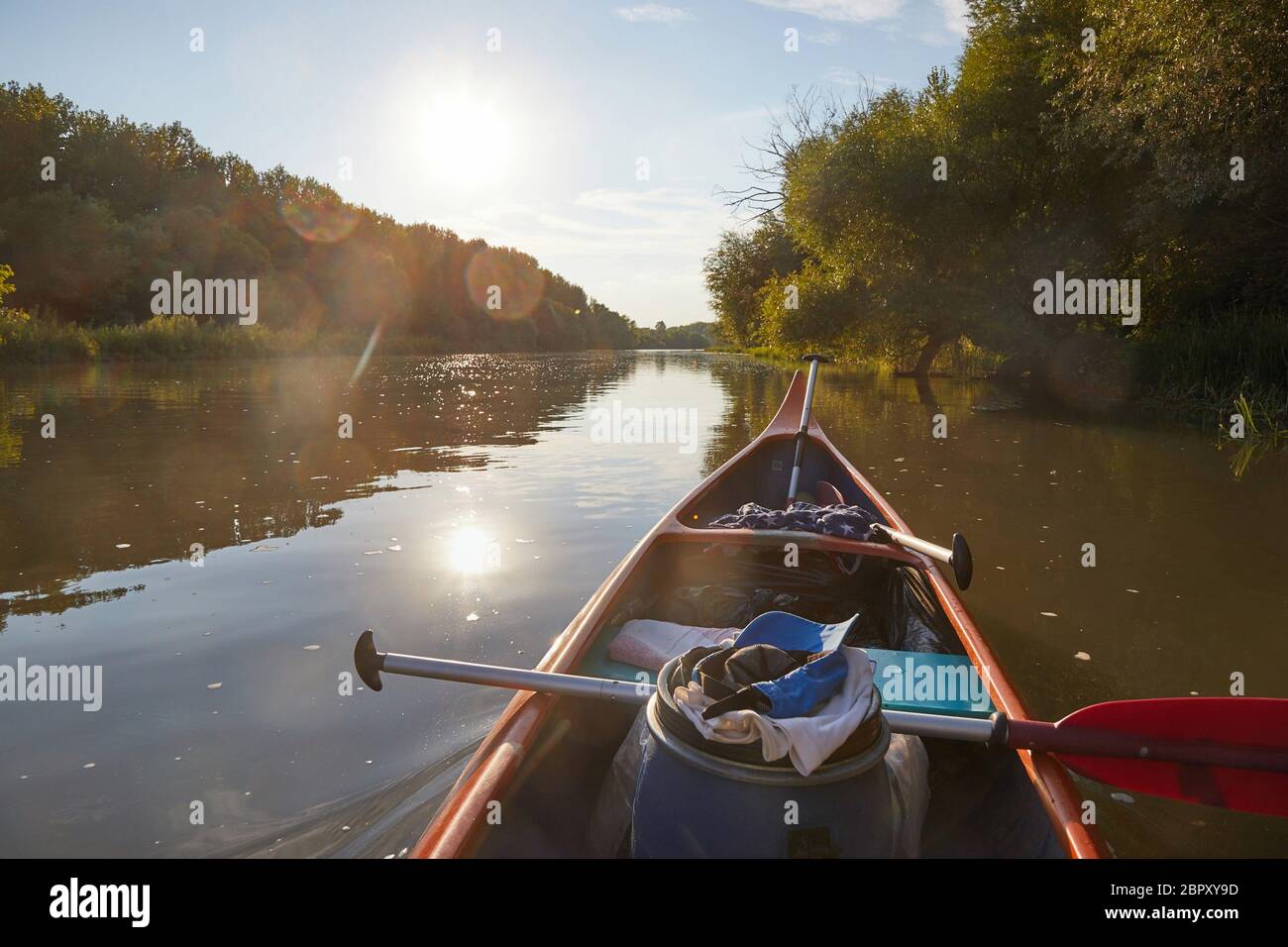 Canoe on the river in bright sunlight flare Stock Photo - Alamy