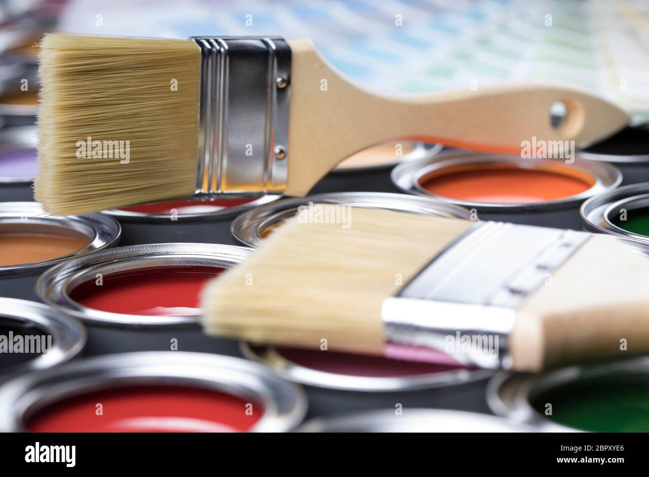 Tin cans with paint, brushes and bright palette of colors Stock Photo ...