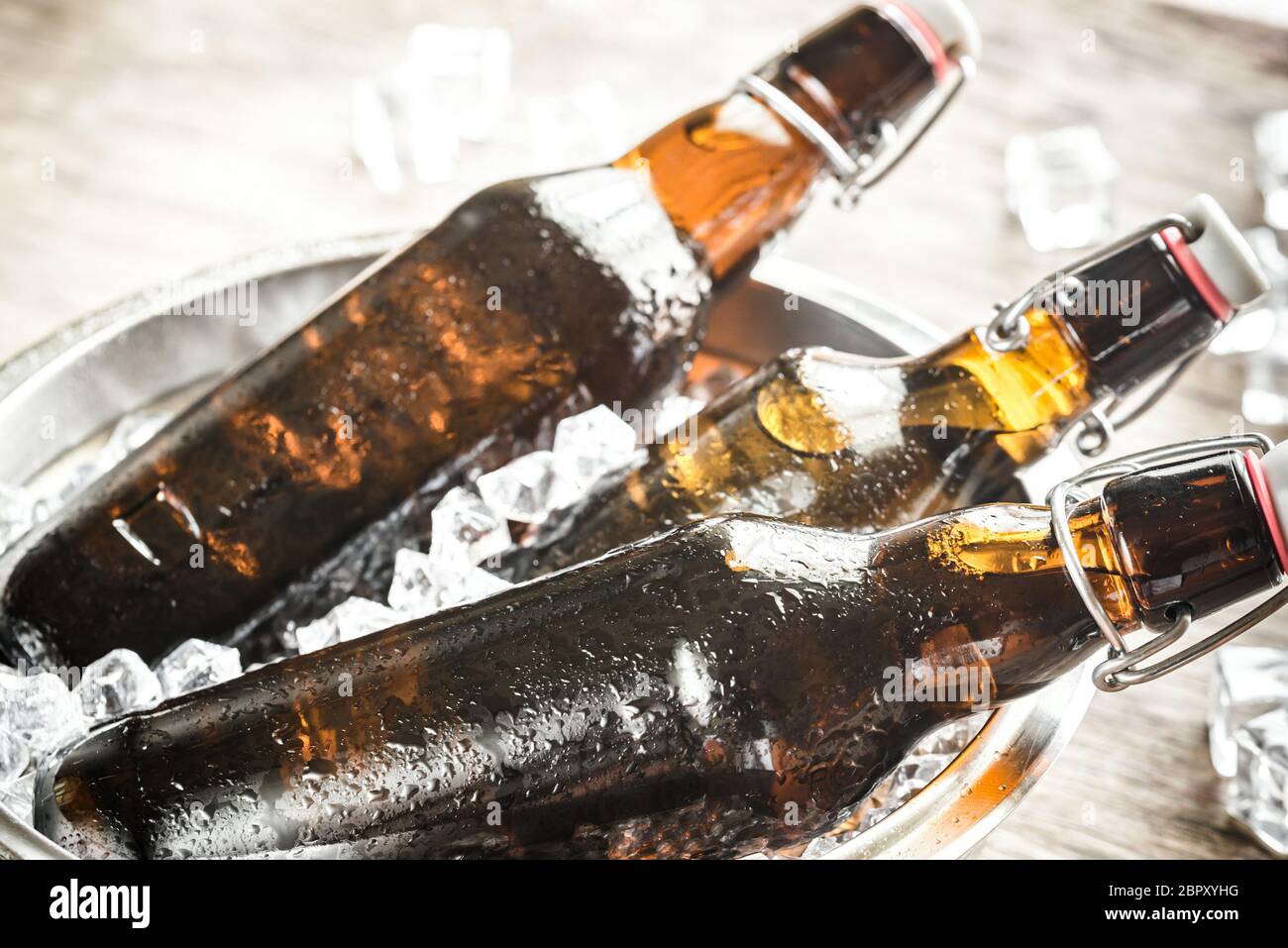 Bottles of beer in ice cubes Stock Photo - Alamy