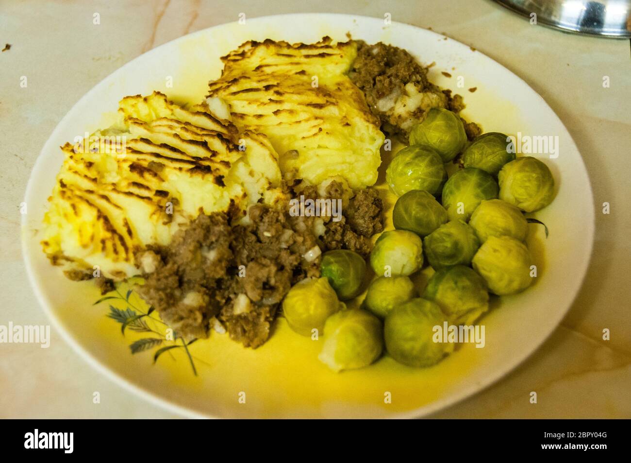 A home made Shepherd's pie with steamed Brussels sprouts Stock Photo ...