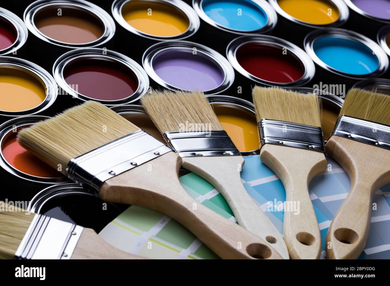 Metal tin cans with color paint and paintbrush Stock Photo - Alamy